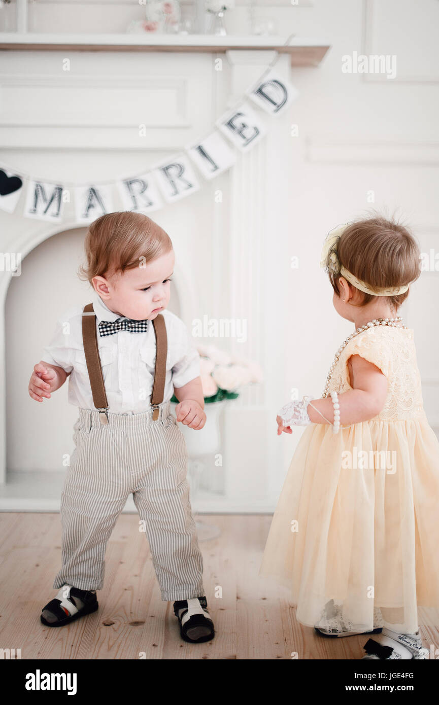 two babies - boy and girl dressed as bride and groom Stock Photo - Alamy