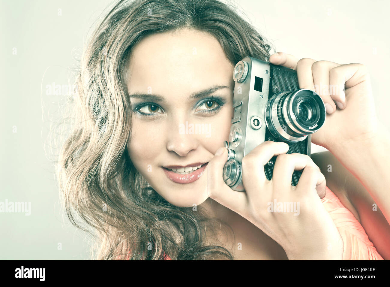 Smiling Caucasian woman holding camera Stock Photo - Alamy