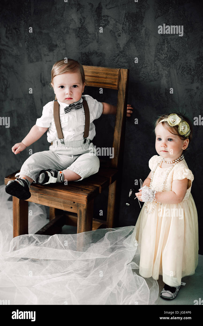 two babies - boy and girl dressed as bride and groom Stock Photo - Alamy