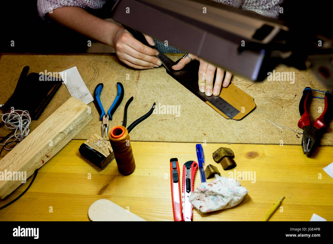 Hands of Caucasian man using ruler in workshop Stock Photo - Alamy