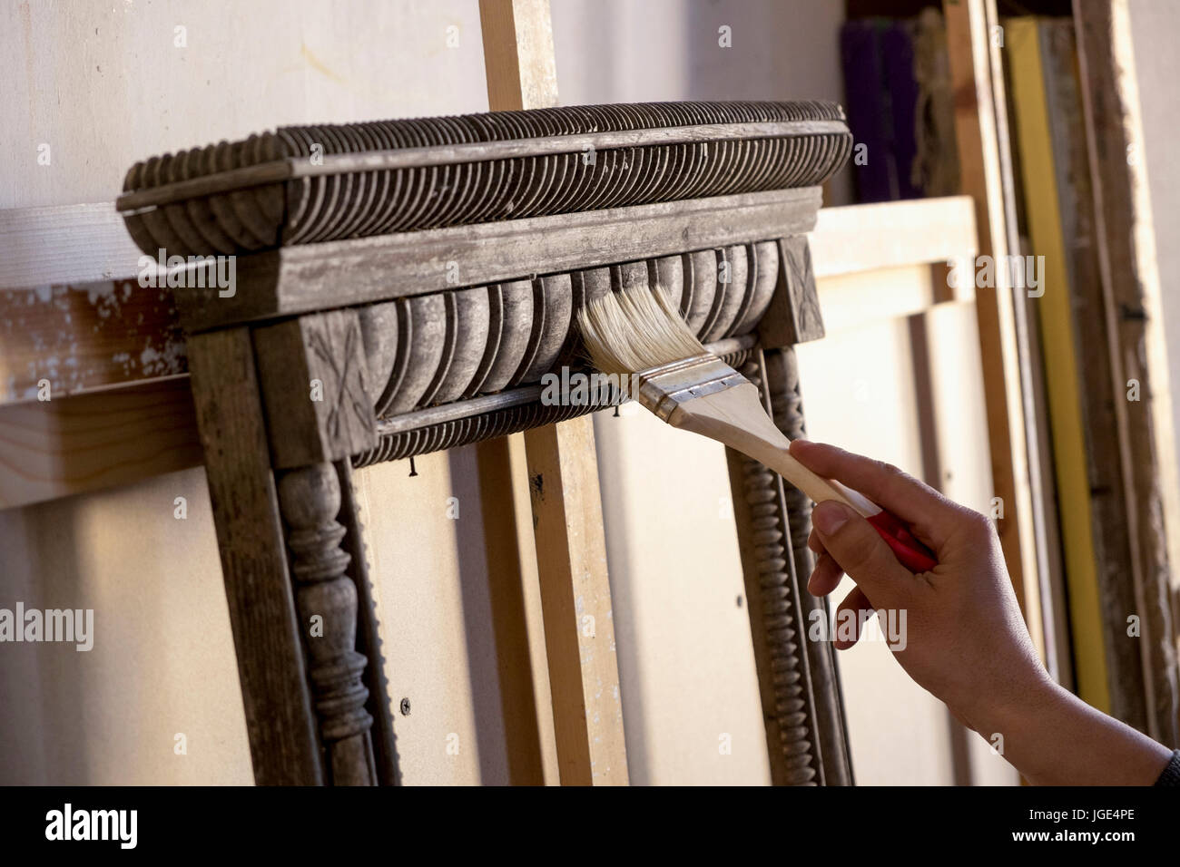 Hand of Caucasian man using paintbrush on picture frame Stock Photo - Alamy