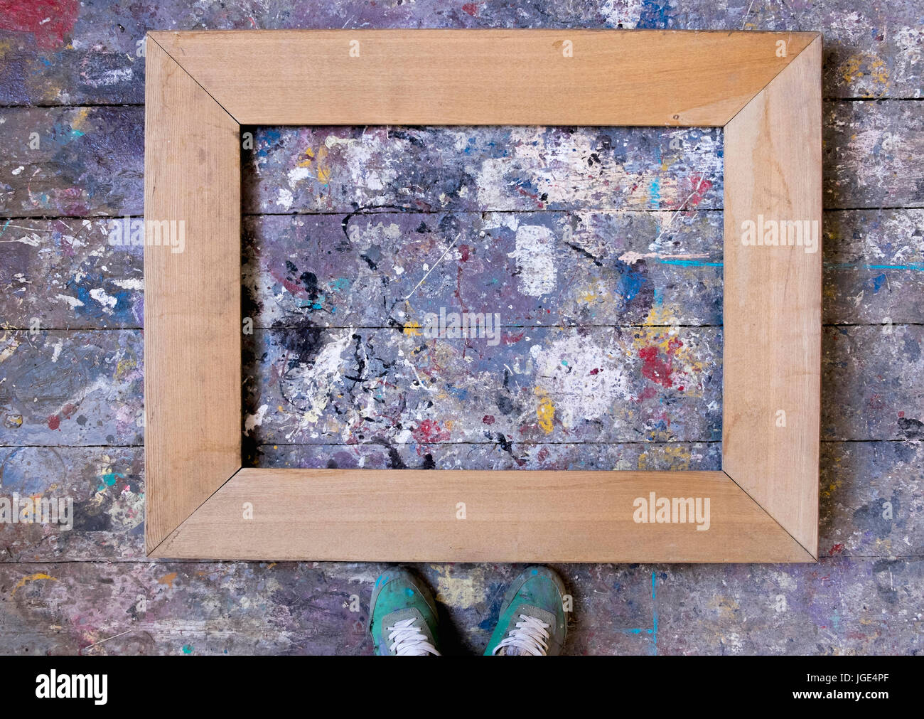 Feet standing over picture frame on wooden floor Stock Photo - Alamy