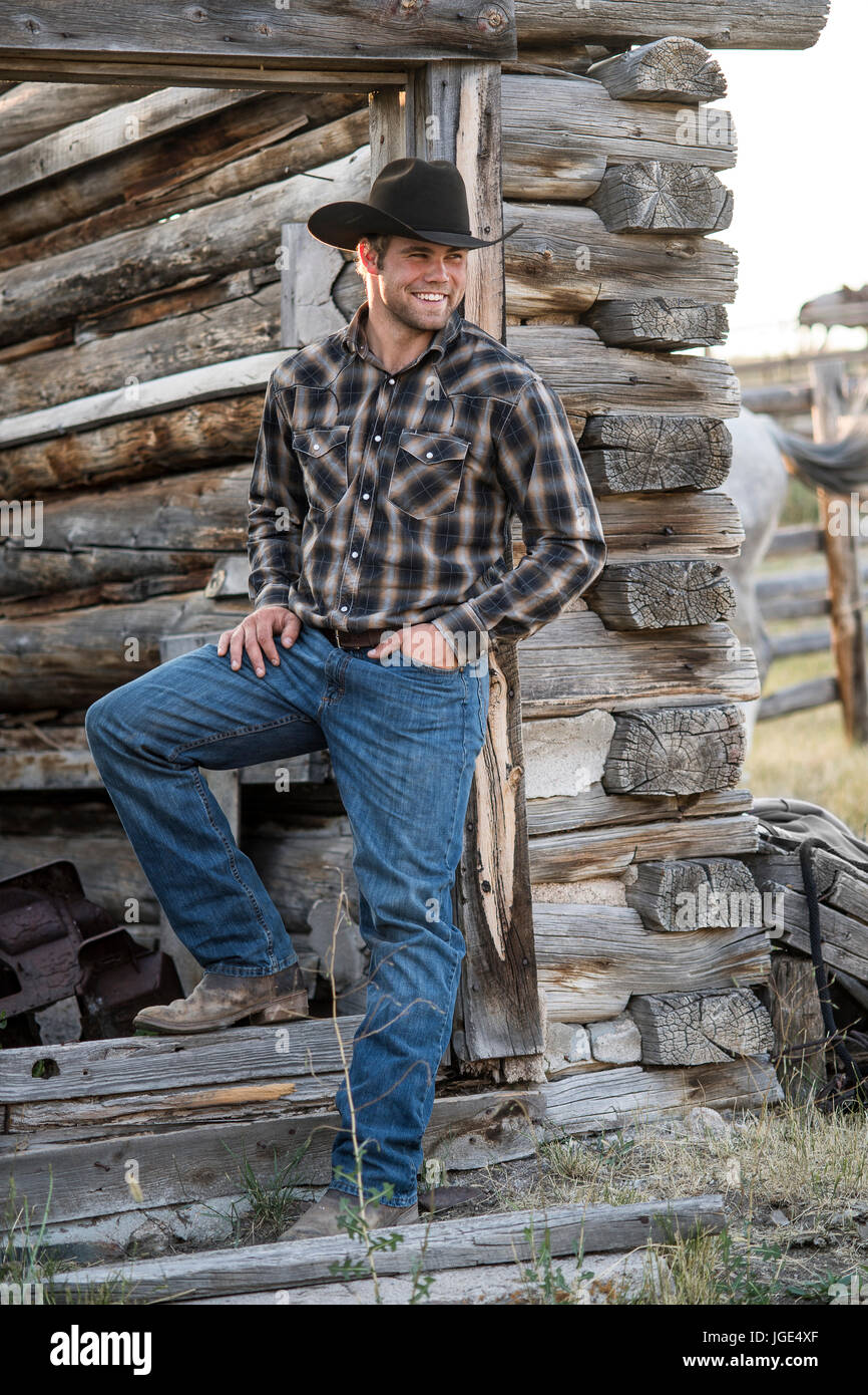 Caucasian cowboy leaning in doorway of cabin Stock Photo - Alamy