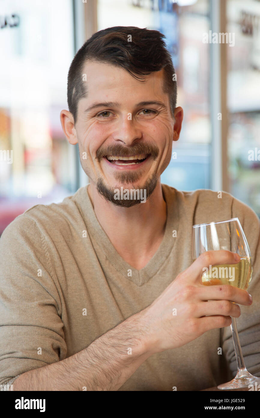 Portrait of Caucasian man drinking white wine Stock Photo - Alamy