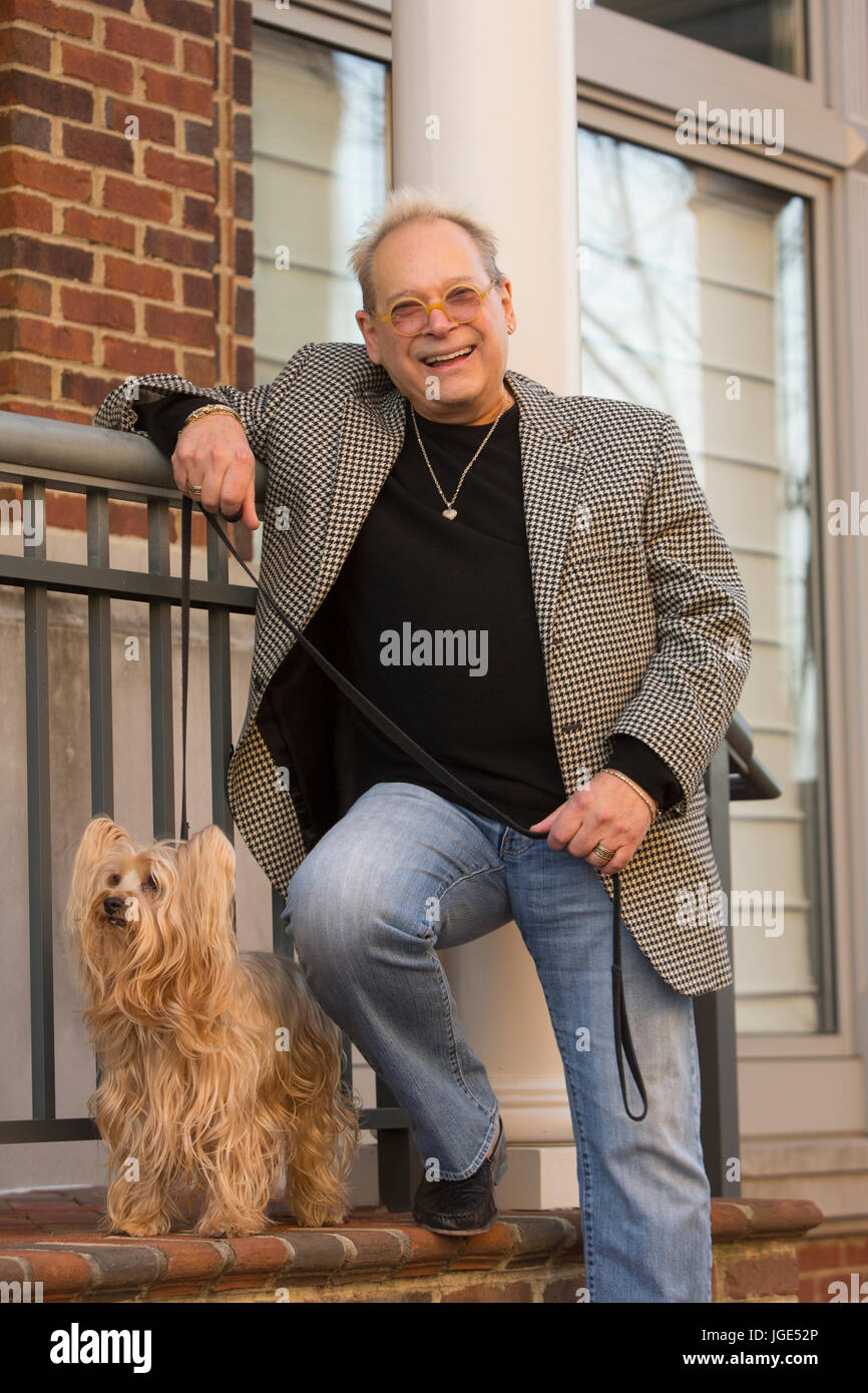 Portrait of Caucasian man leaning on stoop posing with dog Stock Photo ...