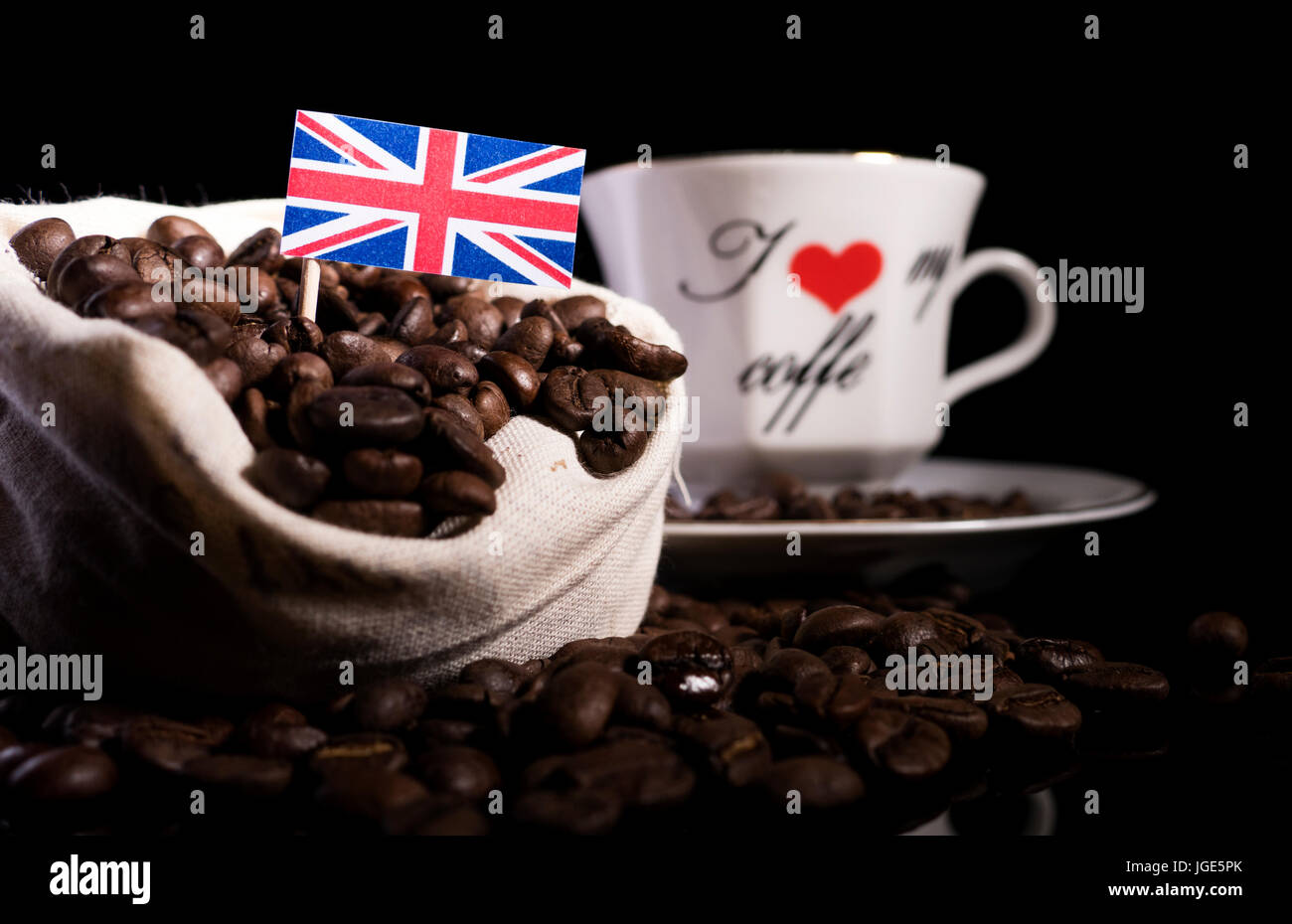 British flag in a bag with coffee beans isolated on black background ...