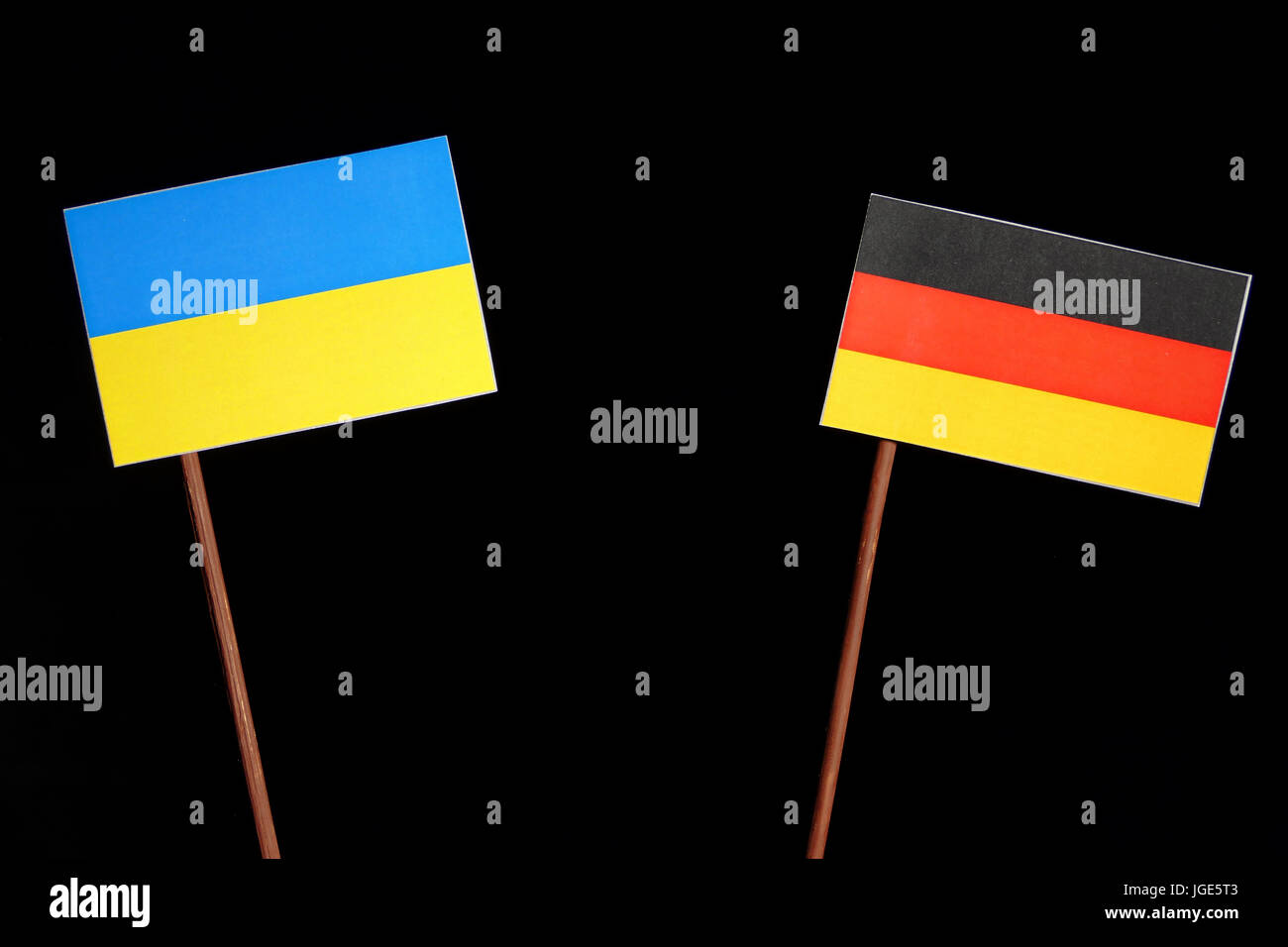 Ukraine flag with German flag isolated on black background Stock Photo ...