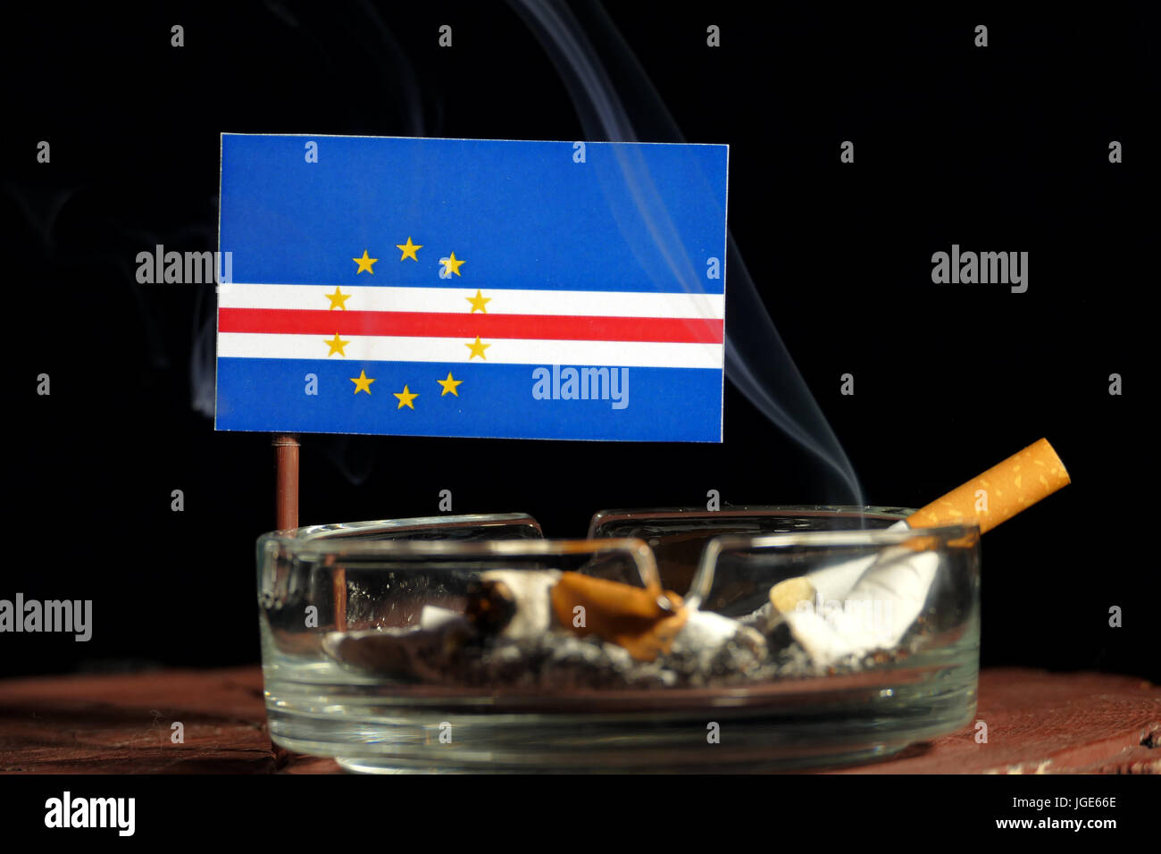 Cape Verde flag with burning cigarette in ashtray isolated on black ...