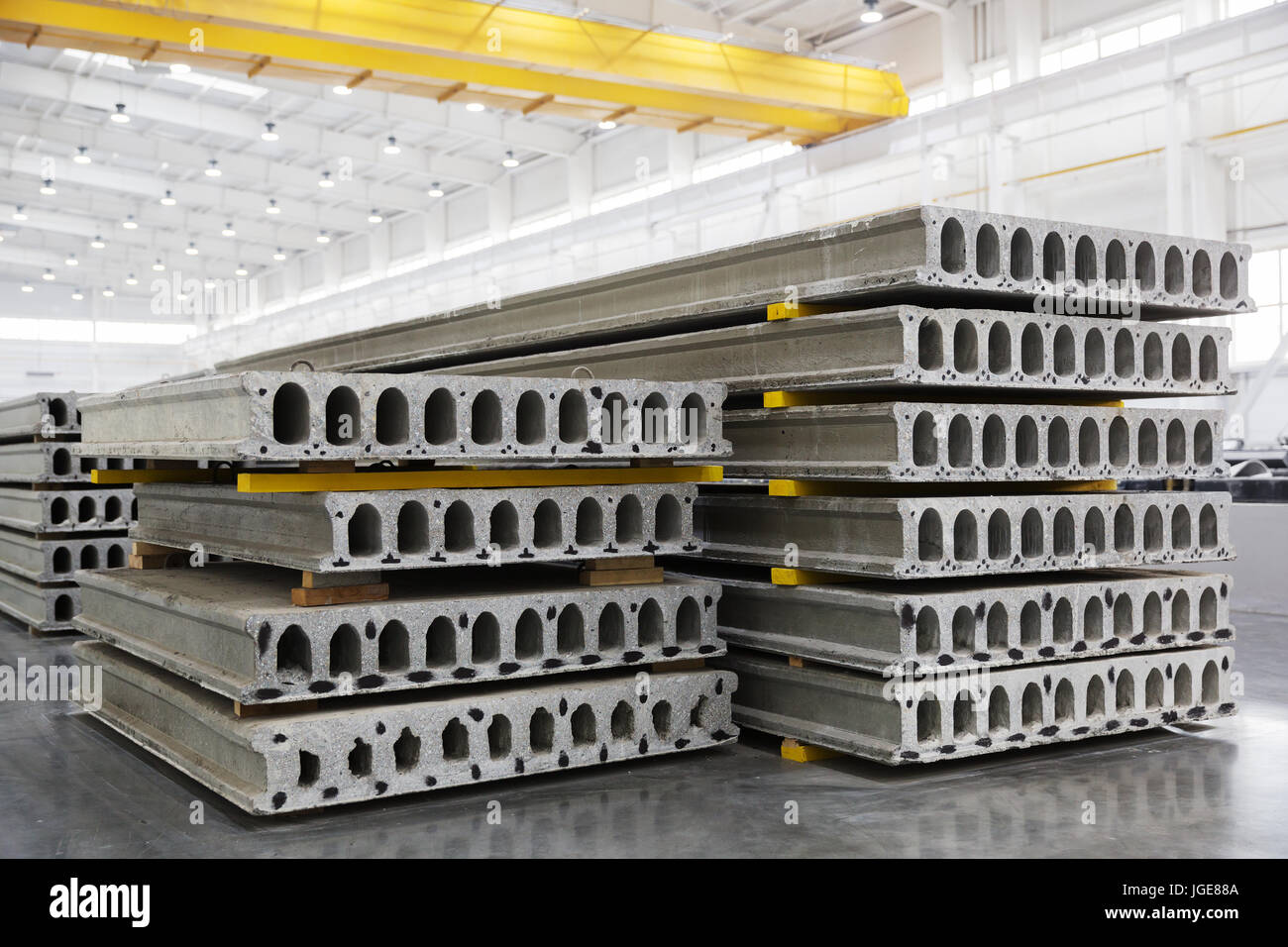 Stack of precast reinforced concrete slabs in a house-building factory ...