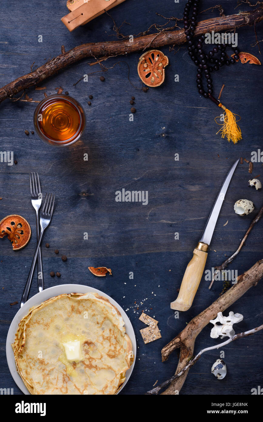 Rusty table with pancakes and wine, hunters hut vintage style. Top view ...