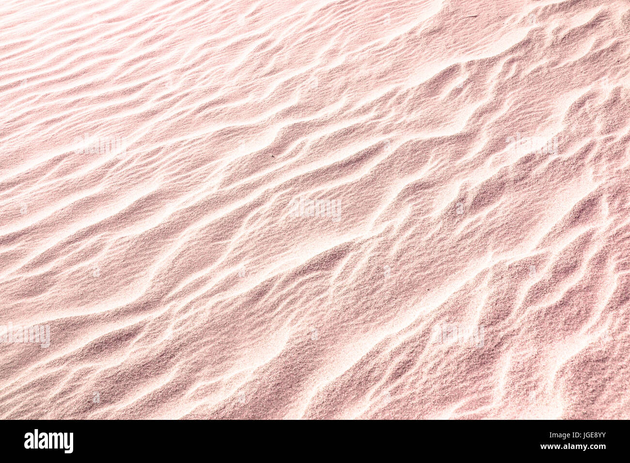 Golden glitter on sand background Stock Photo - Alamy