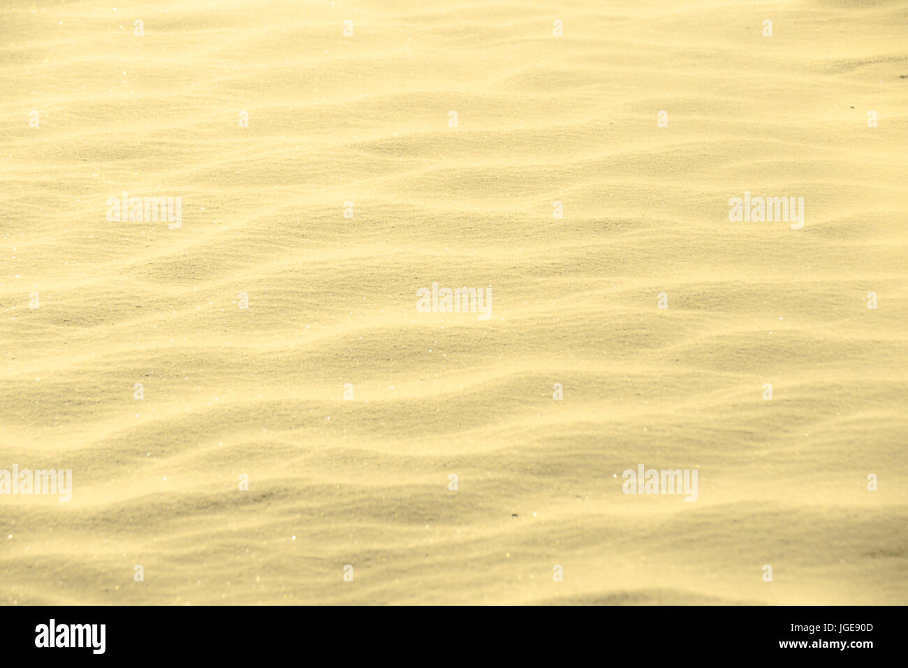 Golden glitter on sand background Stock Photo - Alamy