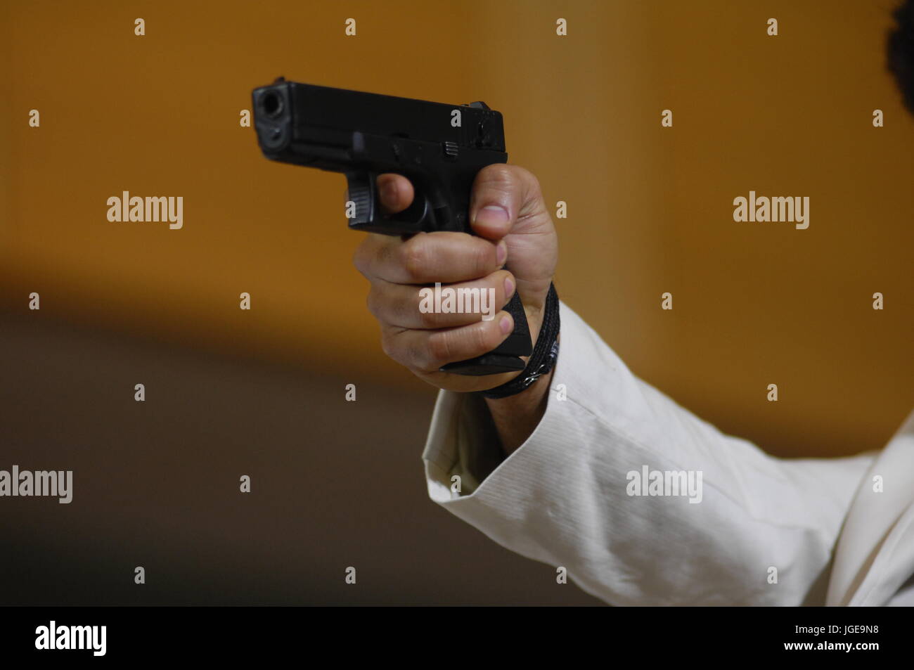 Male hand with revolver Stock Photo - Alamy