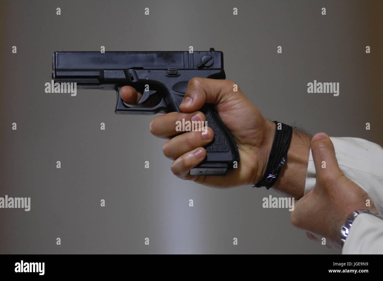 Male hand with revolver Stock Photo - Alamy