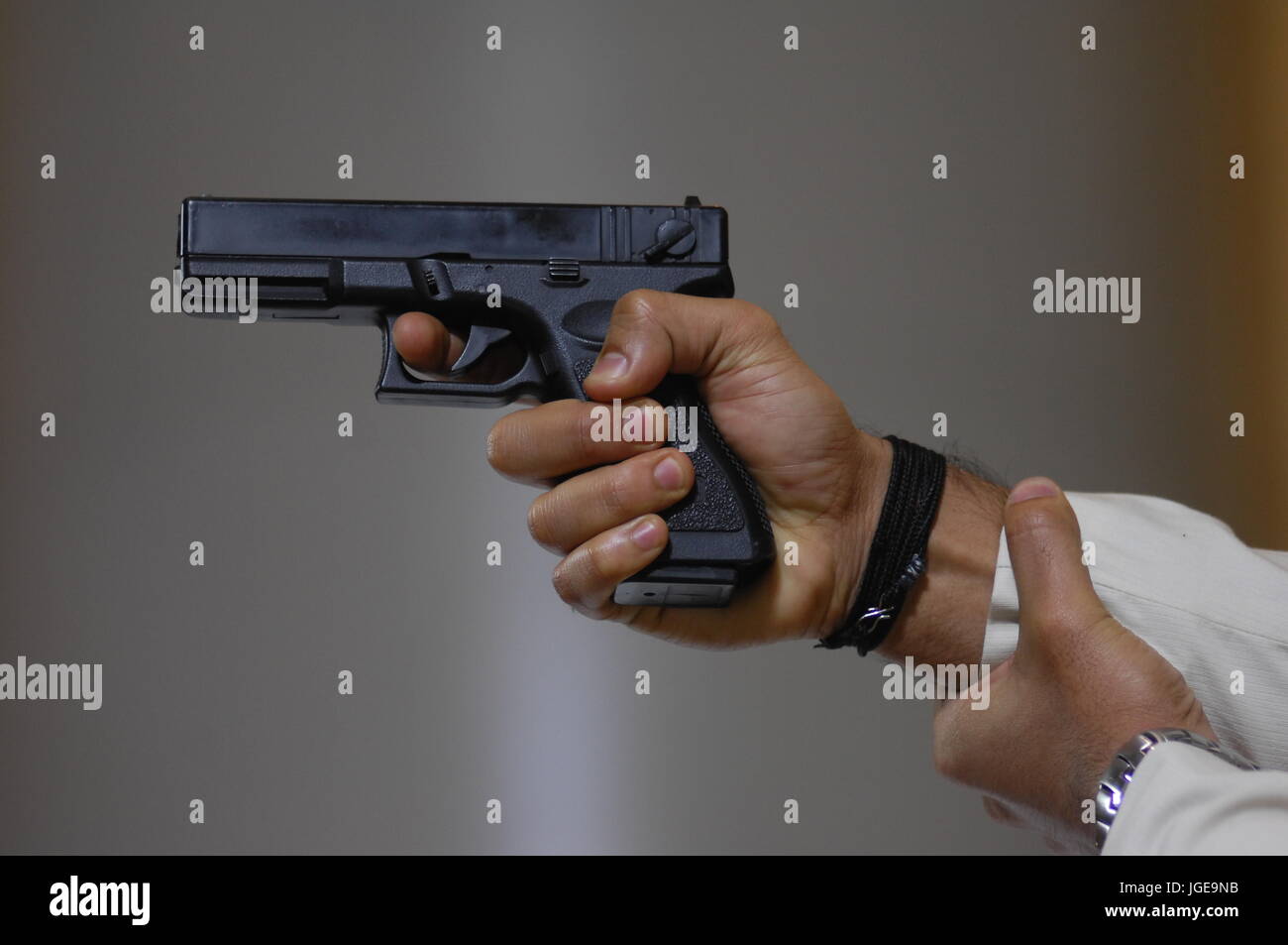 Male hand with revolver Stock Photo - Alamy