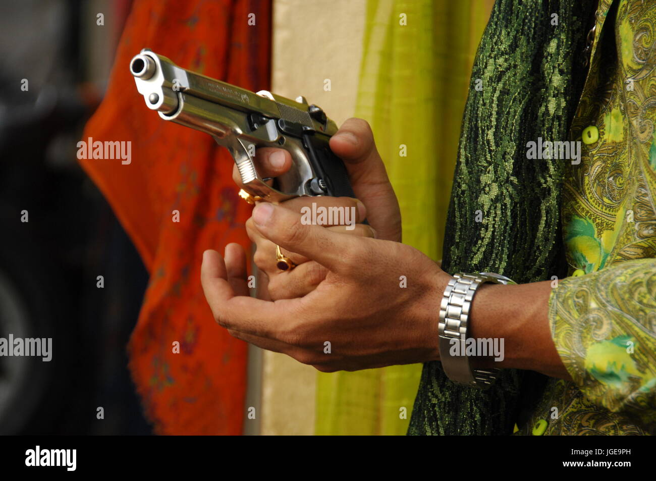 Male hand with revolver Stock Photo - Alamy