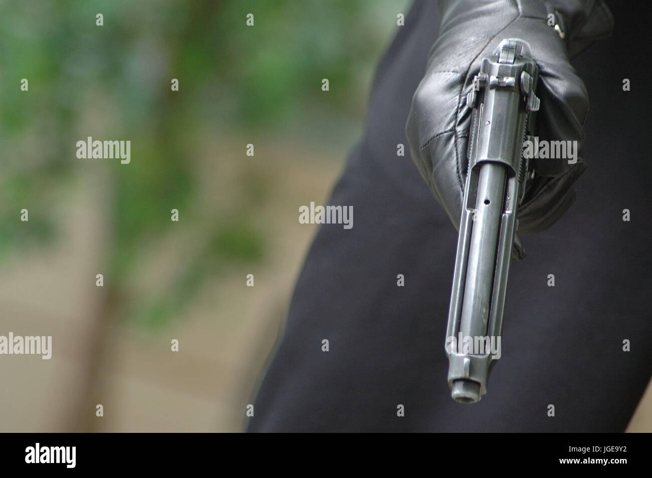 Male hand with revolver Stock Photo - Alamy