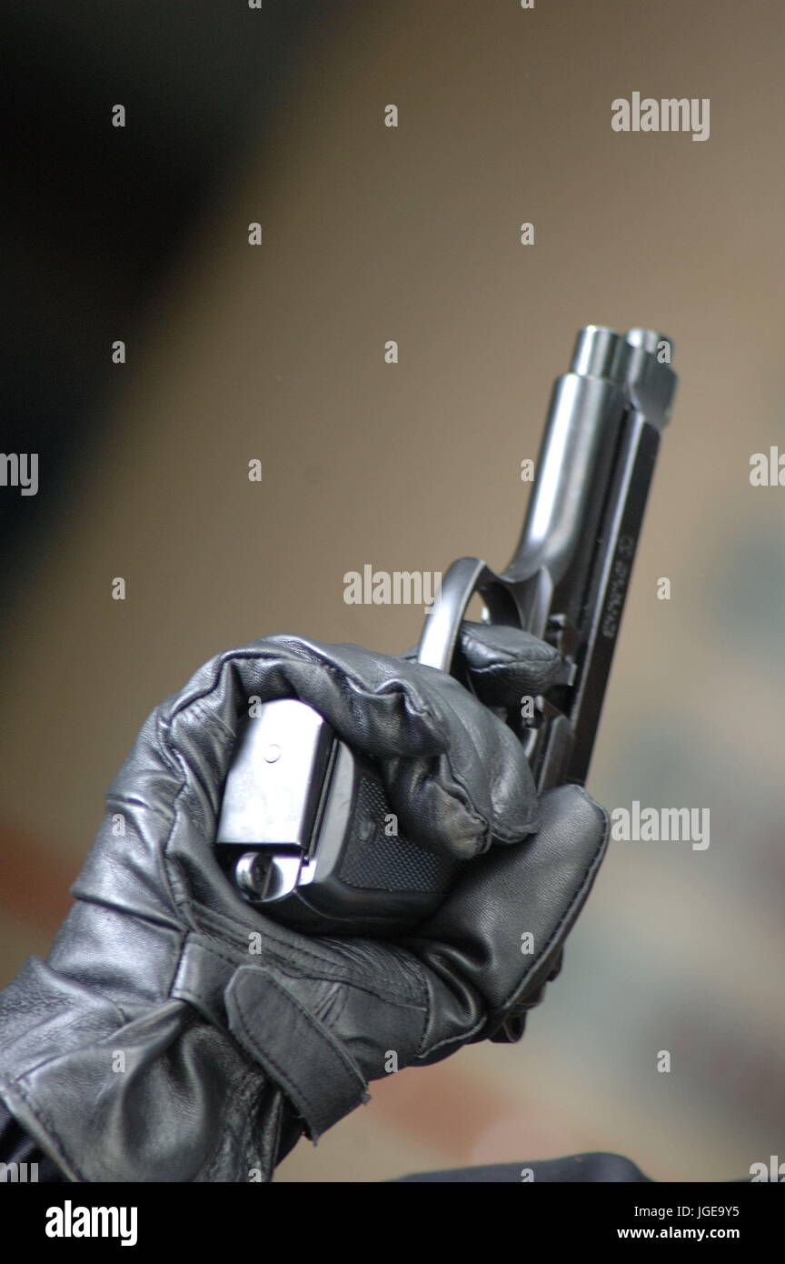 Male hand with revolver Stock Photo - Alamy