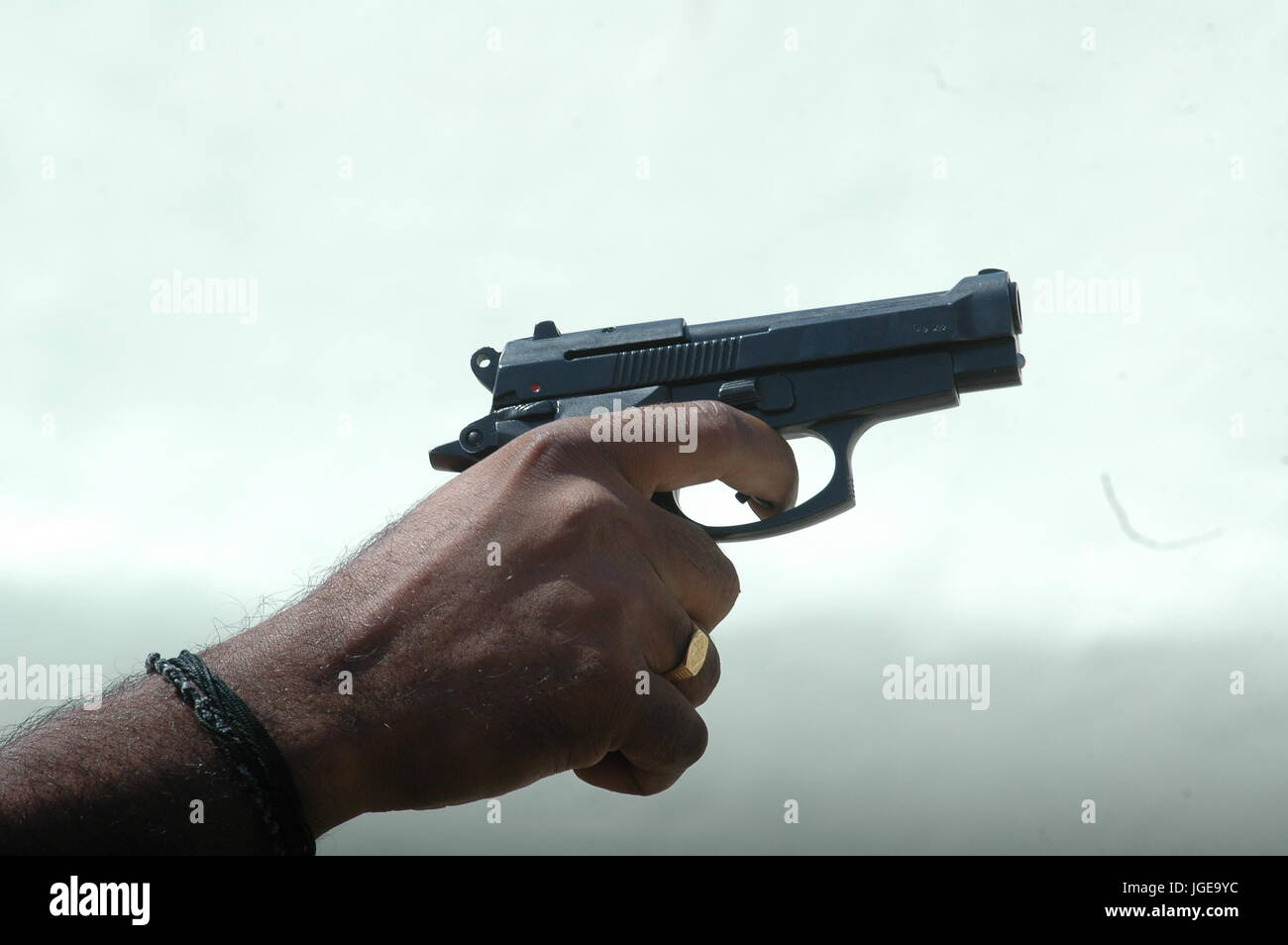 Male Hand with Gun Stock Photo - Alamy
