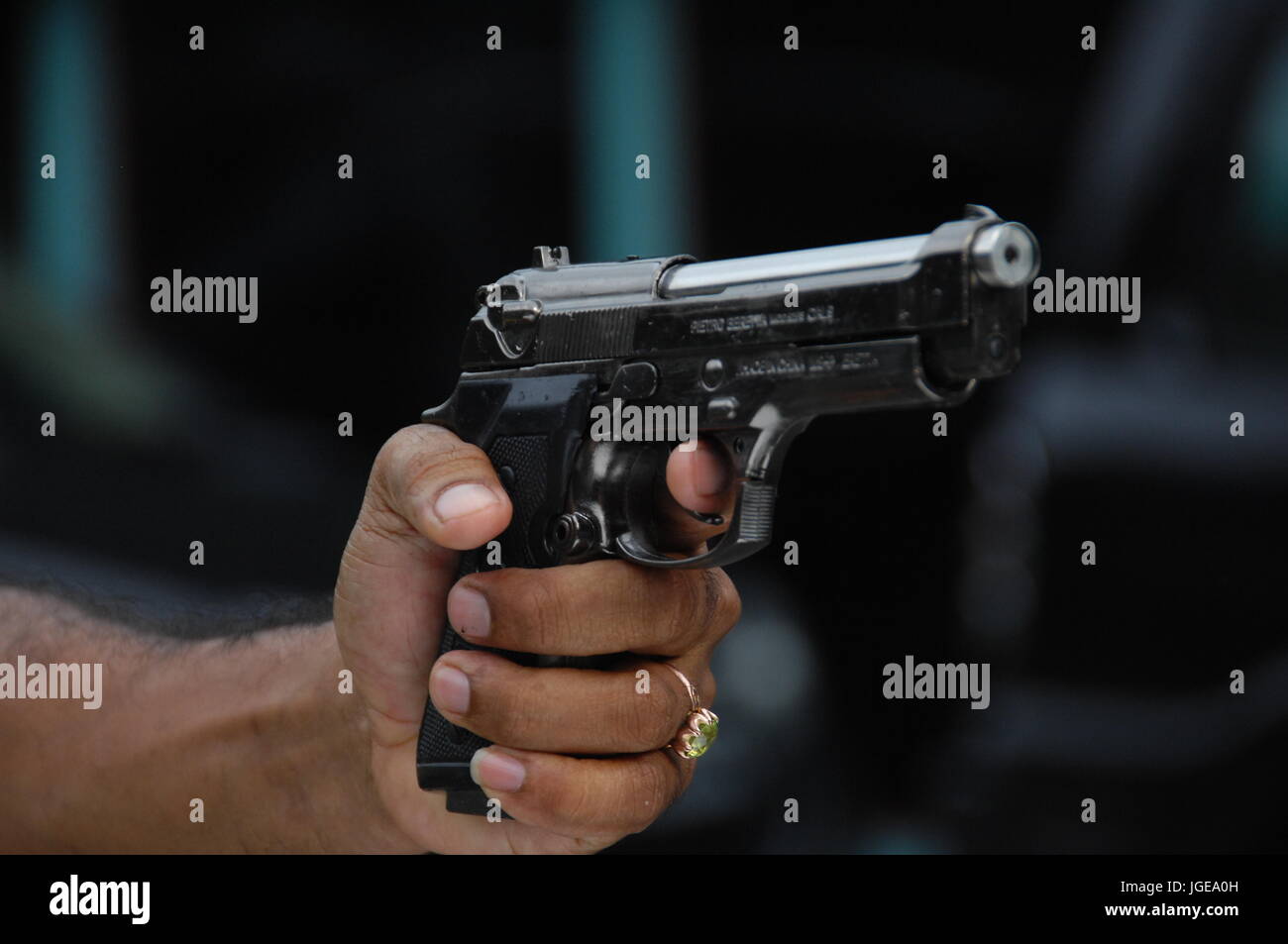Male Hand with Gun Stock Photo - Alamy