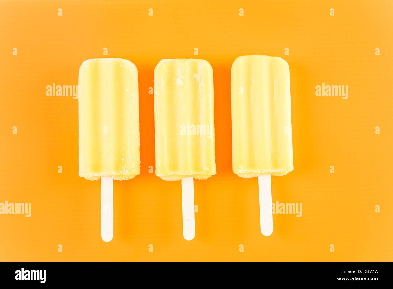 Multicolored fruit ice cream bars on colored background Stock Photo - Alamy