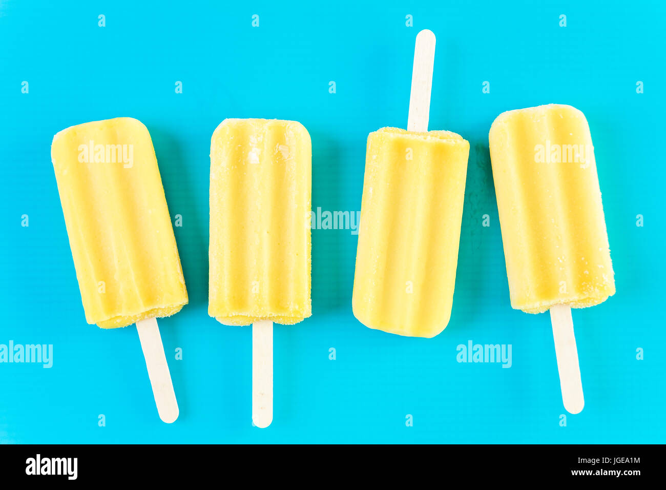 Multicolored fruit ice cream bars on colored background Stock Photo - Alamy