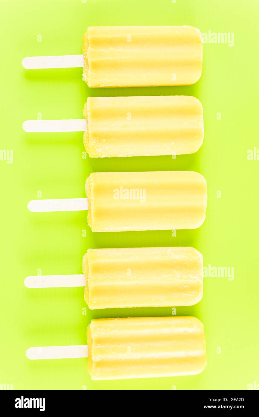 Multicolored fruit ice cream bars on colored background Stock Photo - Alamy