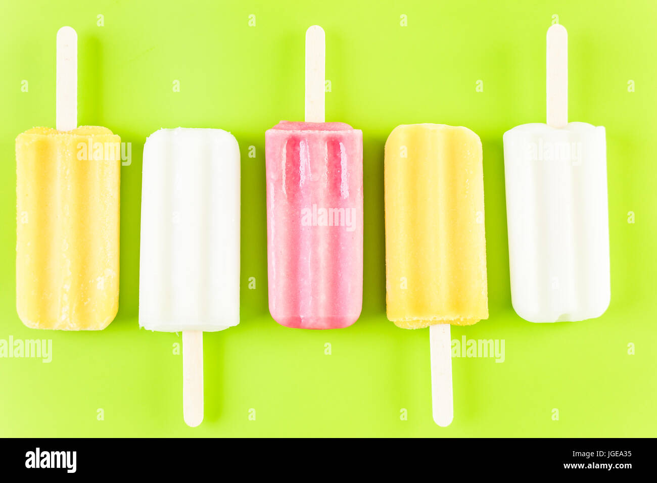 Multicolored fruit ice cream bars on colored background Stock Photo - Alamy