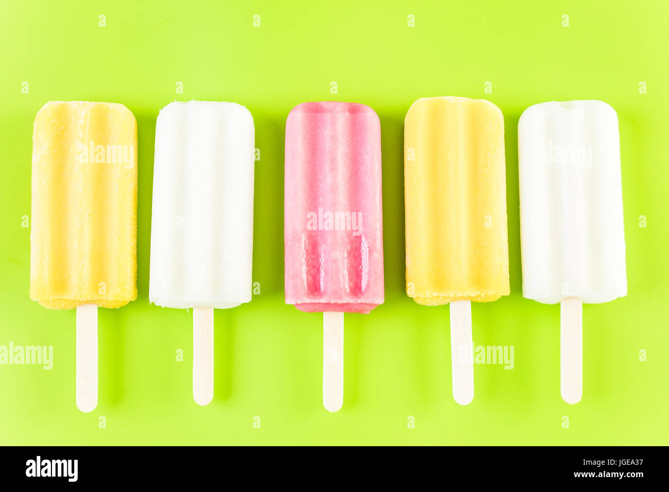 Multicolored fruit ice cream bars on colored background Stock Photo - Alamy