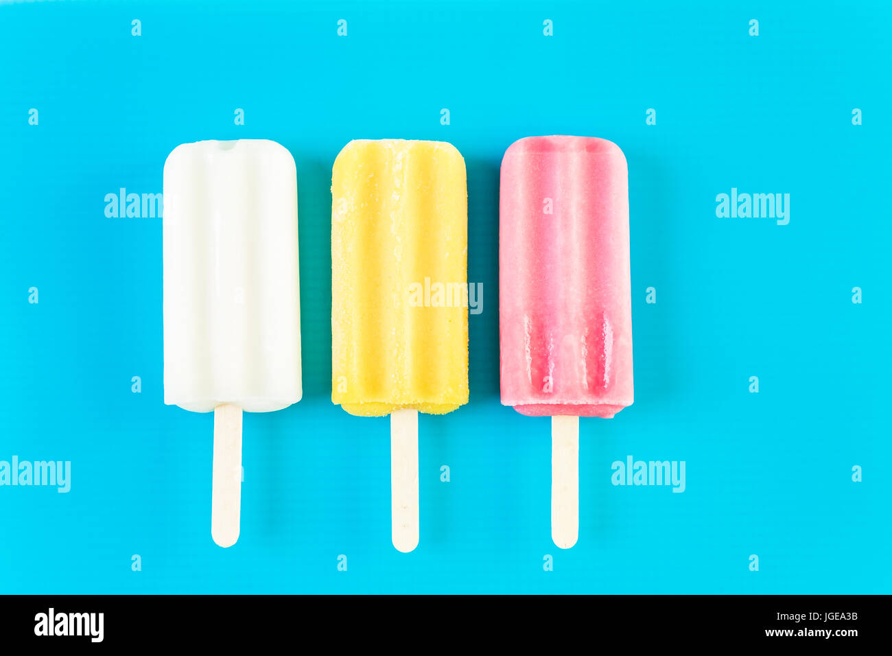 Multicolored fruit ice cream bars on colored background Stock Photo - Alamy