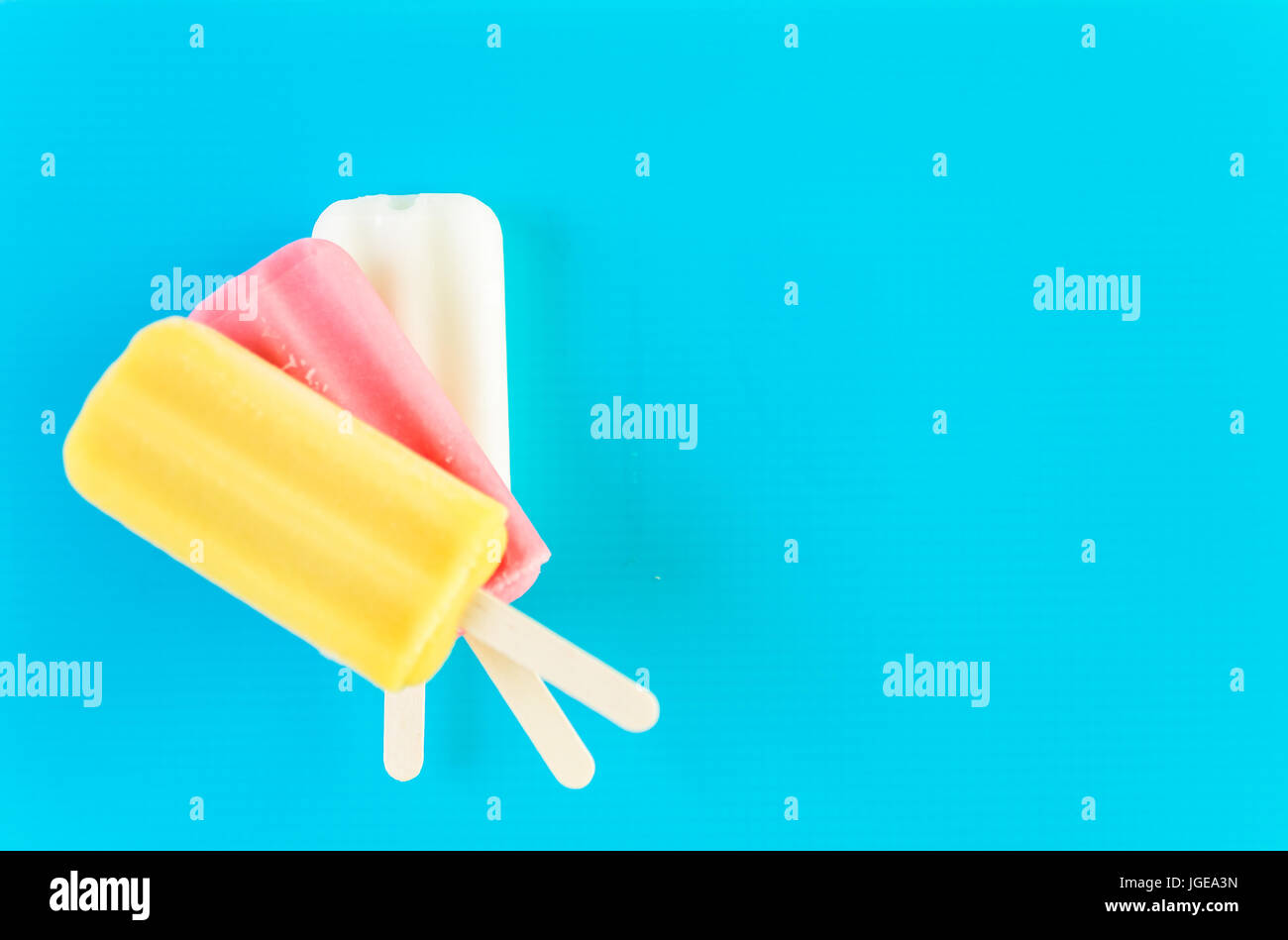Multicolored fruit ice cream bars on colored background Stock Photo - Alamy