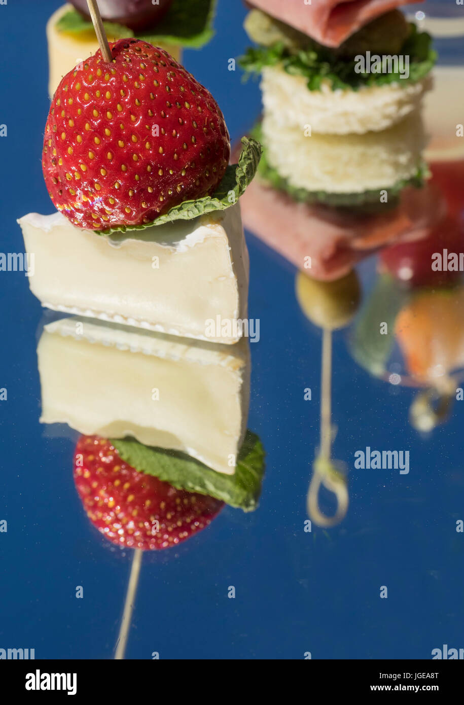 Set of different canapes and snacks served on a platter with a mirror ...