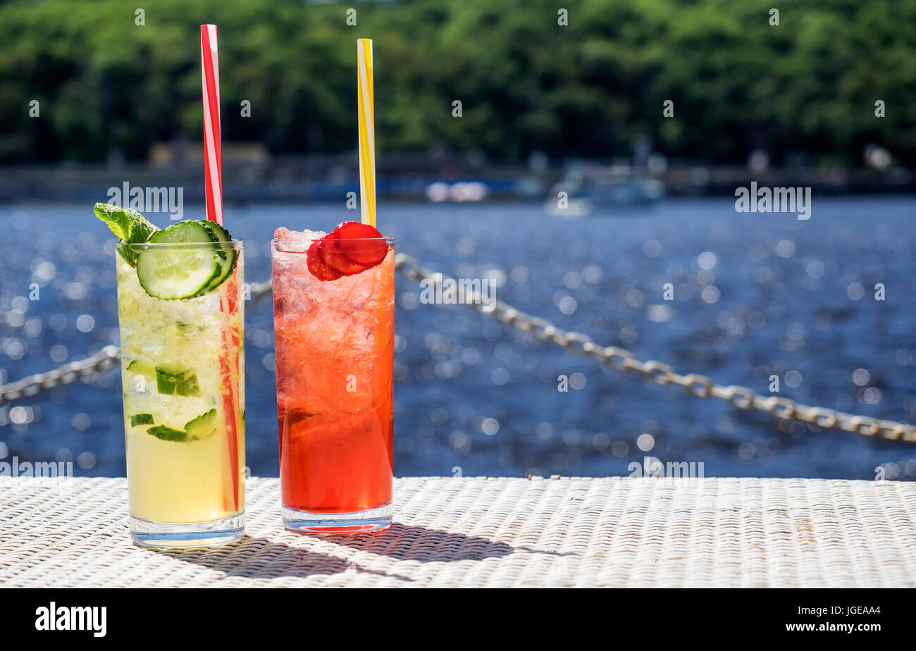 fresh summer lemonade over nature blue water Stock Photo - Alamy