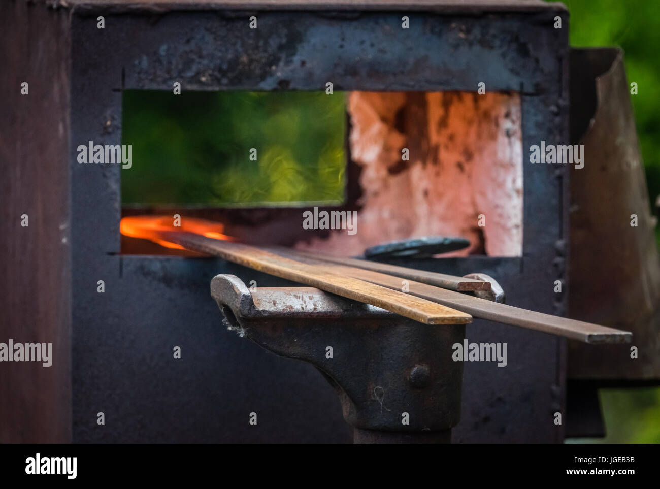 A blacksmith inserting steel rods into the hot oven during medieval ...