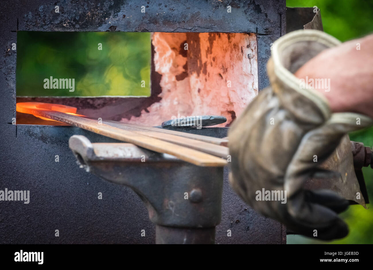 A blacksmith inserting steel rods into the hot oven during medieval ...