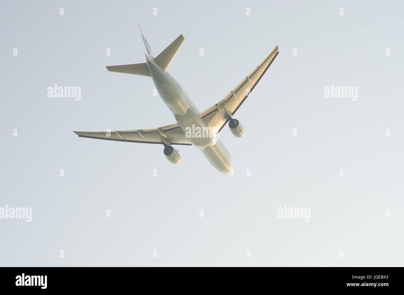Airplane in blue sky Stock Photo - Alamy