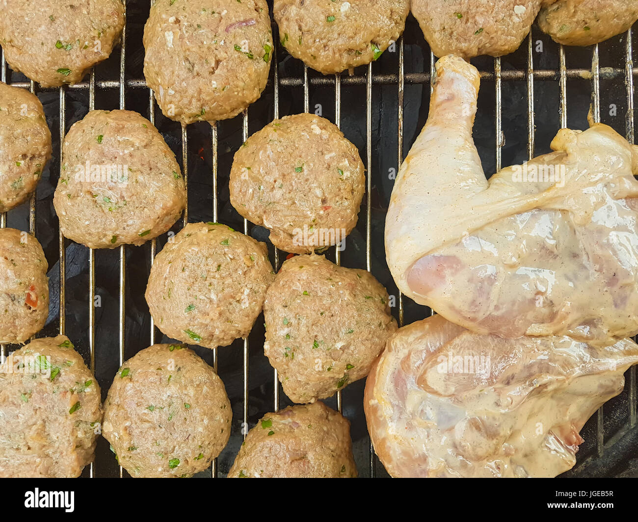 Chicken and beef on a grill Stock Photo - Alamy