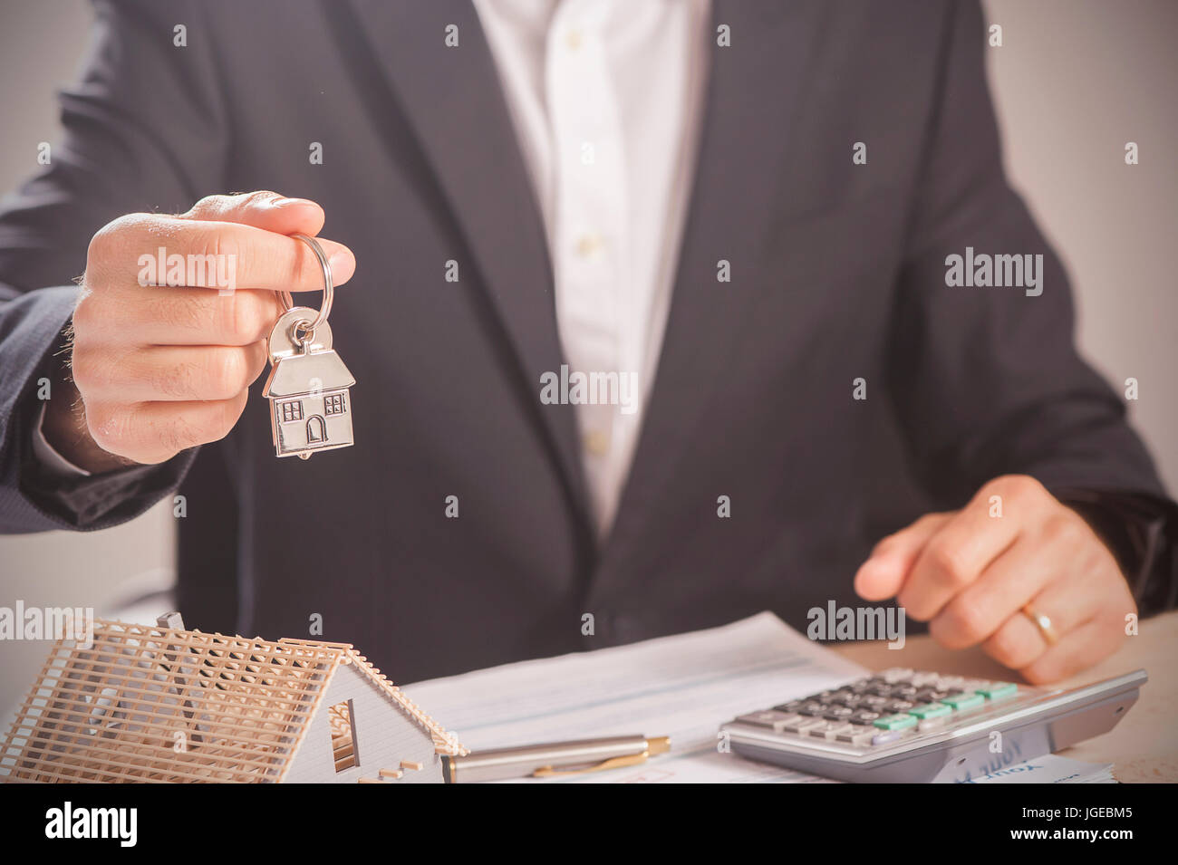 Real estate agent handing over house keys Stock Photo - Alamy
