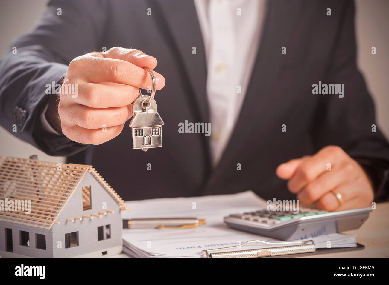 Real estate agent handing over house keys Stock Photo - Alamy