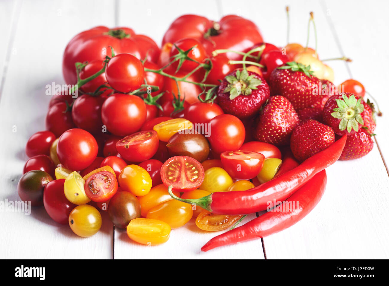 Red vegetables and fruit on white wood Stock Photo - Alamy