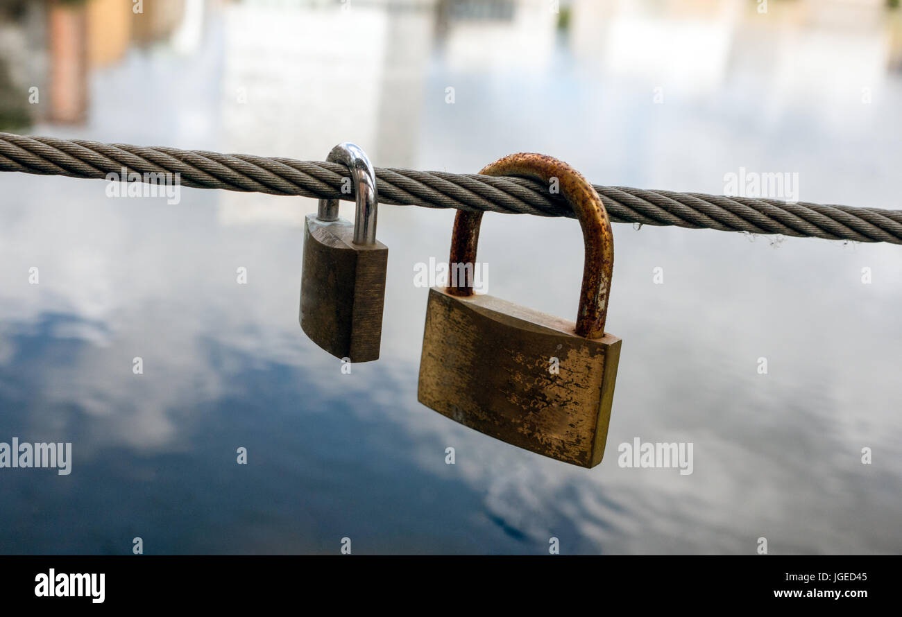 Padlocks on the side of a bridge, safety wires Stock Photo - Alamy