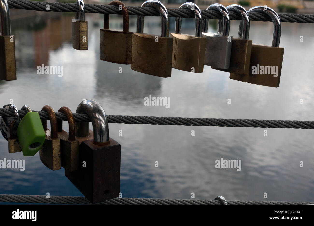 Padlocks on the side of a bridge, safety wires Stock Photo - Alamy