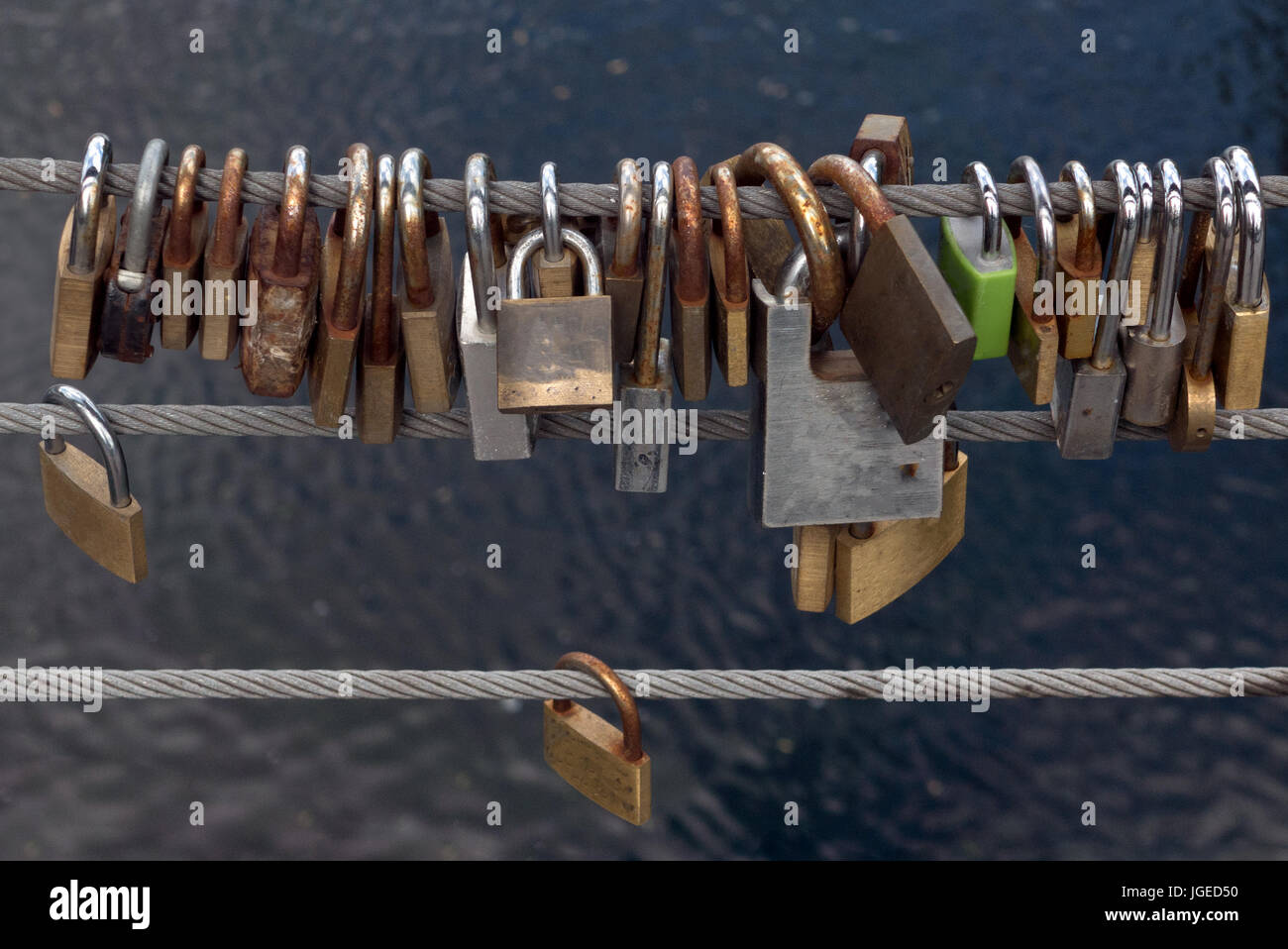 Padlocks on the side of a bridge, safety wires Stock Photo - Alamy