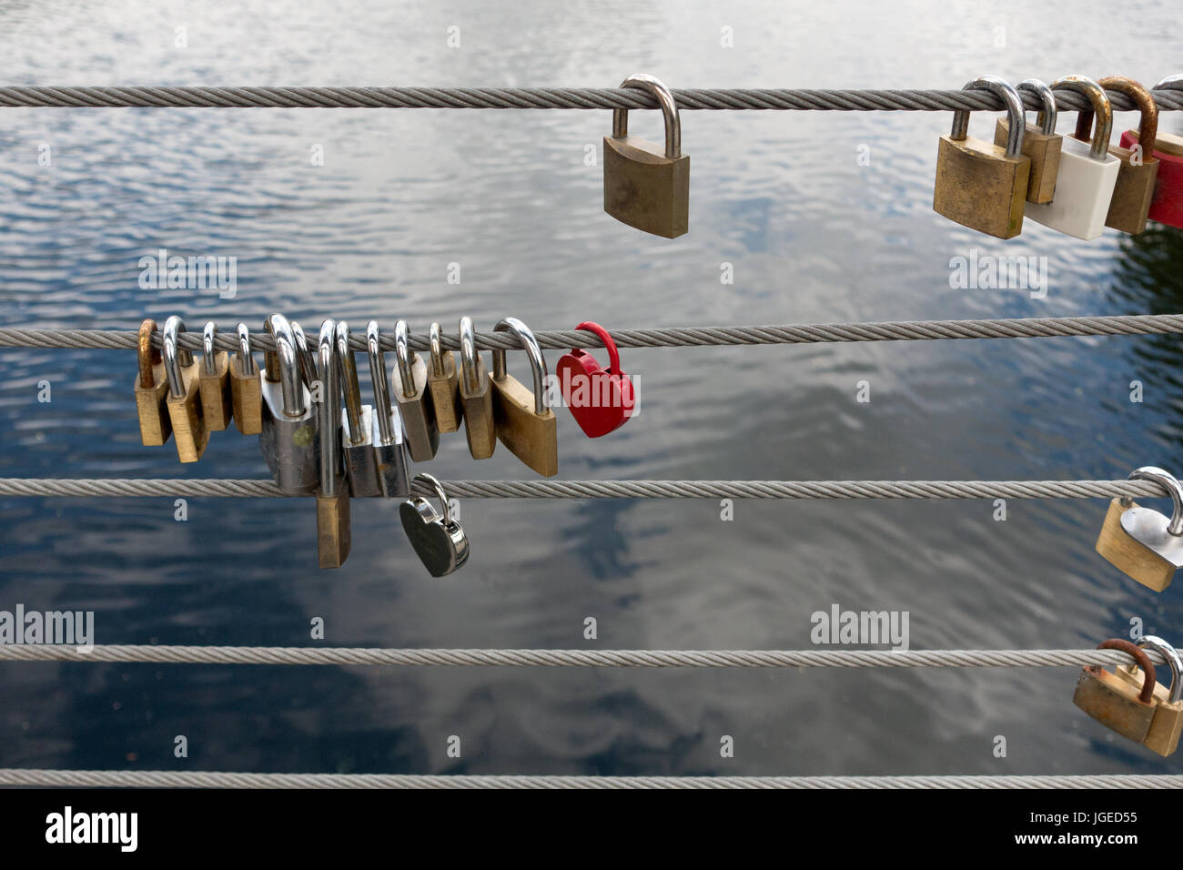 Padlocks on the side of a bridge, safety wires Stock Photo - Alamy