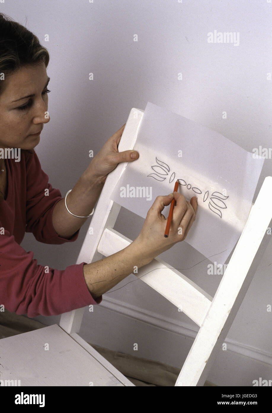 Woman tracing design onto wooden chair Stock Photo - Alamy