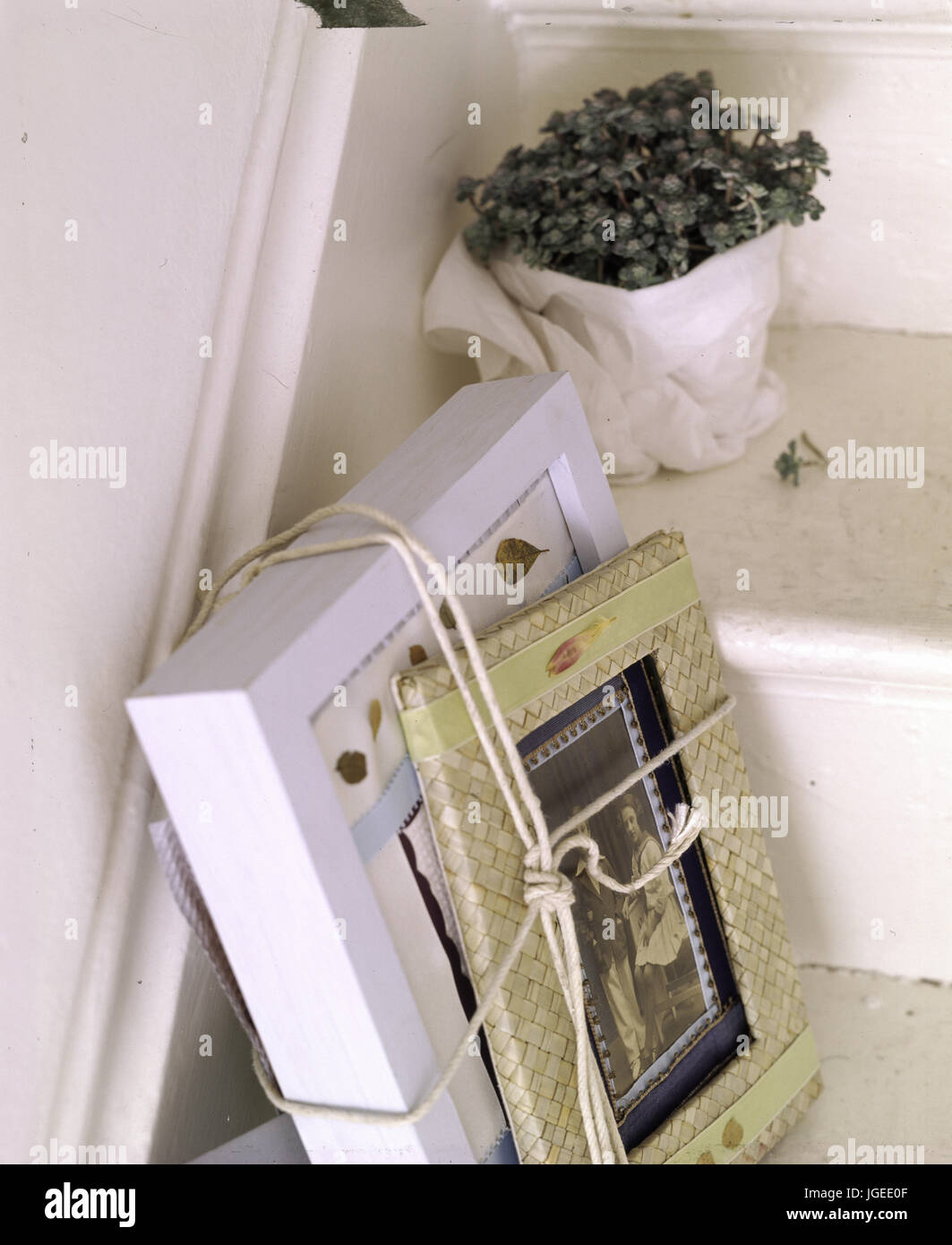 Pictures ready to move, tied up with string on stairs Stock Photo - Alamy