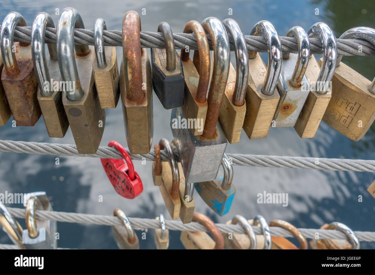 Padlocks on the side of a bridge, safety wires Stock Photo - Alamy