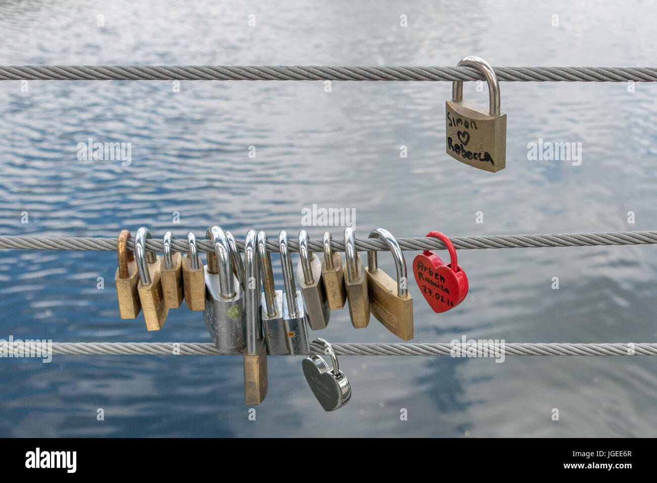 Padlocks on the side of a bridge, safety wires Stock Photo - Alamy