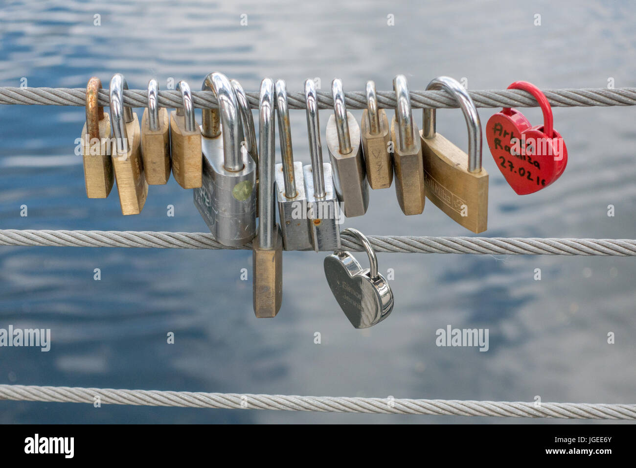 Padlocks on the side of a bridge, safety wires Stock Photo - Alamy