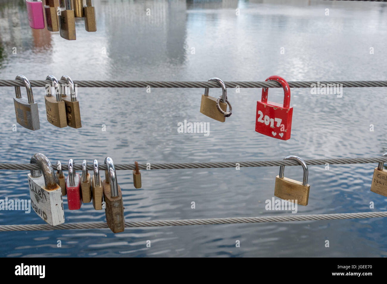Padlocks on the side of a bridge, safety wires Stock Photo - Alamy